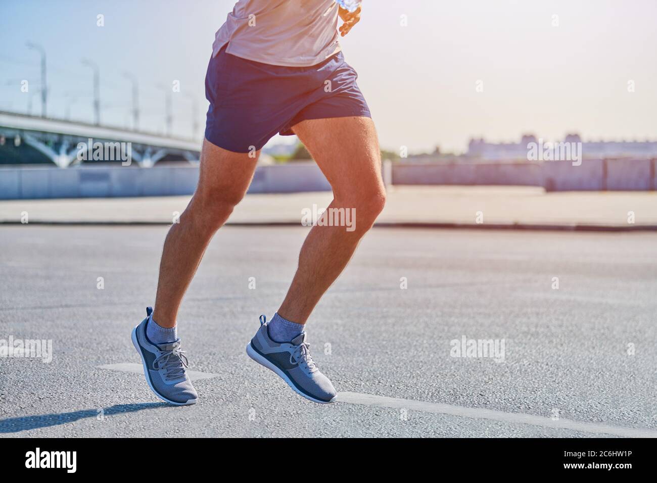 Running man. Athletic man jogging in sportswear on city road. Healthy lifestyle, fitness sport ...