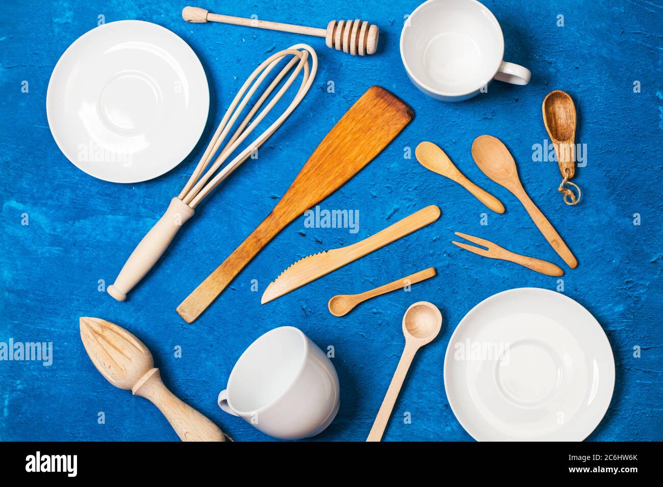 Kitchen utensils on a textured classic blue background in a top view ...