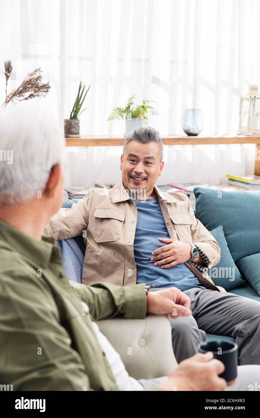 Cheerful brothers talking sitting hi-res stock photography and images ...