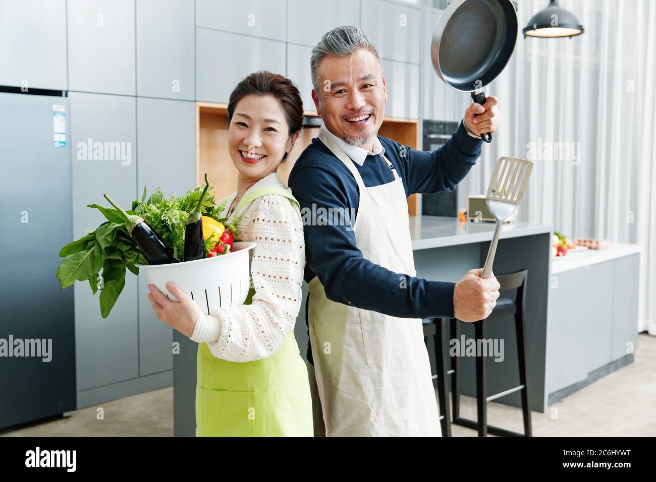 Middle-aged couples in the kitchen cooking Stock Photo - Alamy