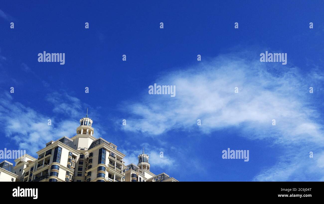 Shenzhen, China: residential buildings under blue sky and white clouds ...