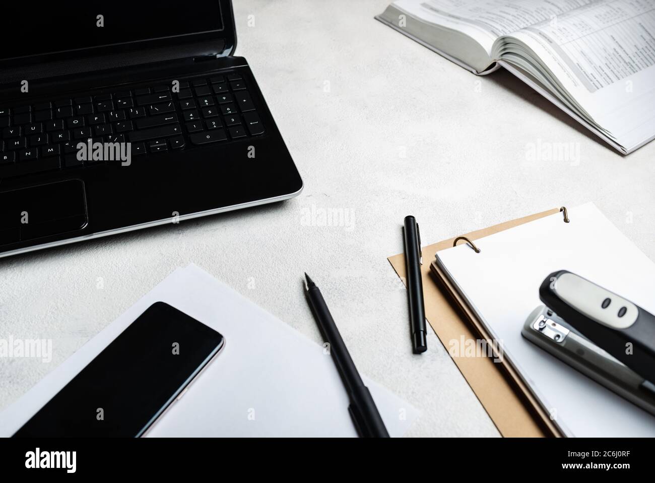 office desk with laptop smartphone books pens notebook close-up Stock ...
