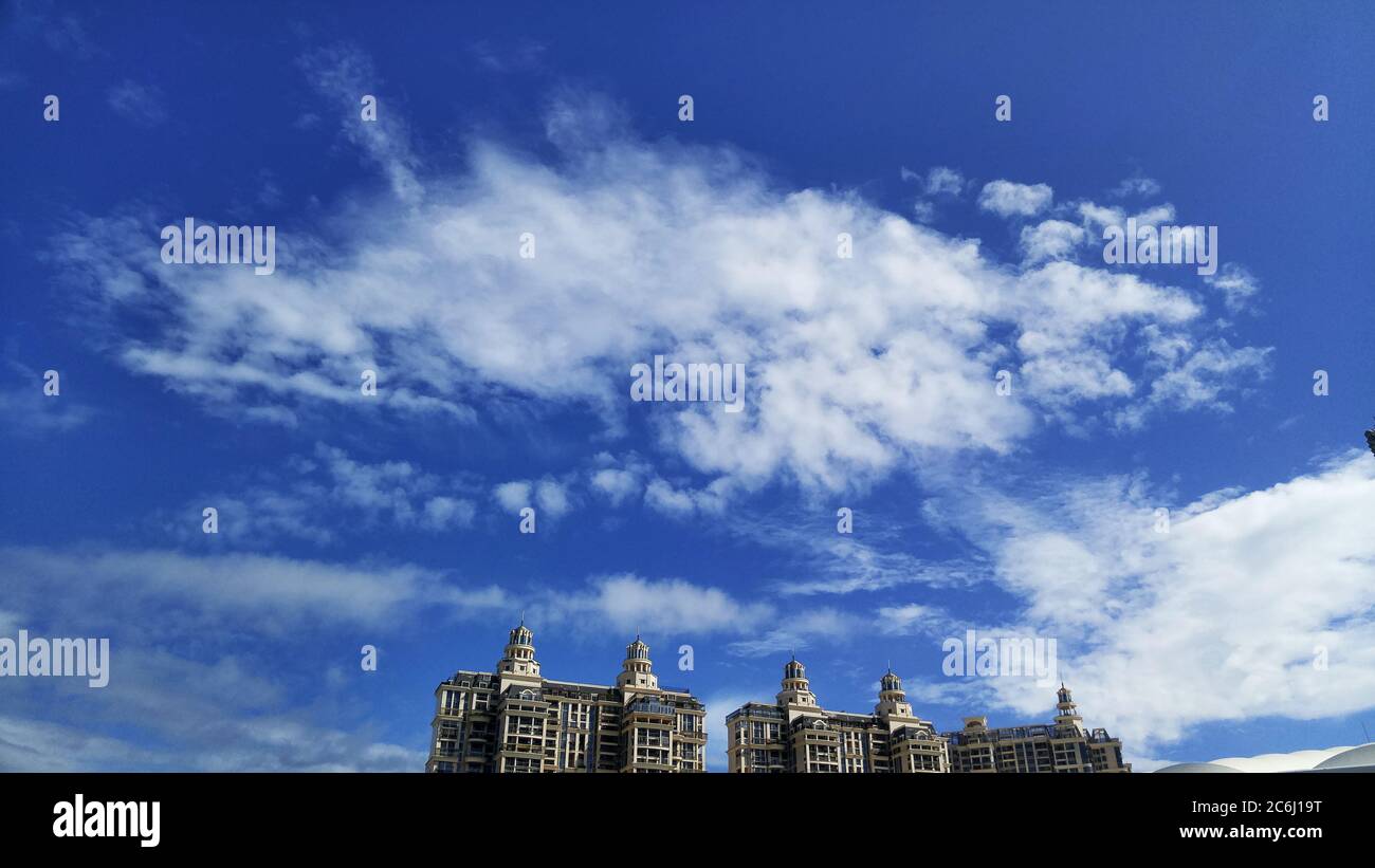 Shenzhen, China: residential buildings under blue sky and white clouds ...