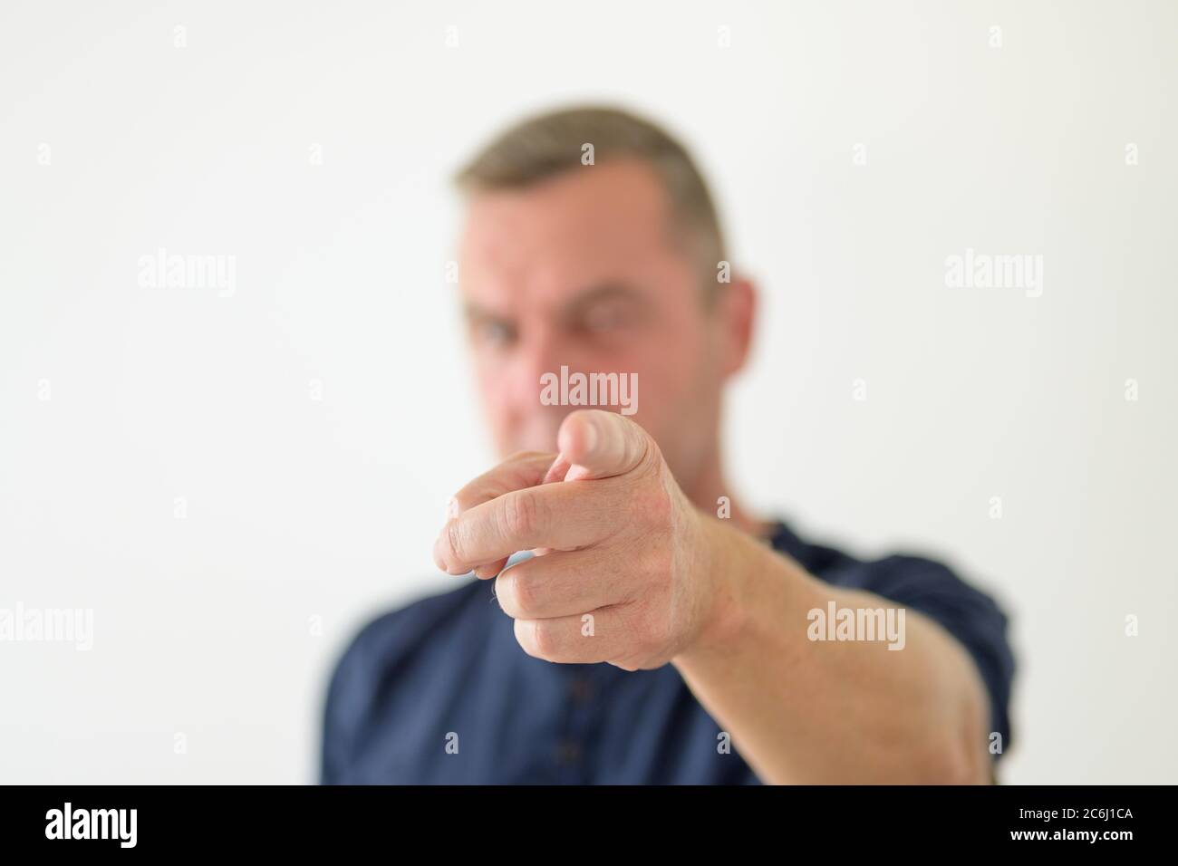 Man pointing a finger of blame at the camera with focus to the hand in ...