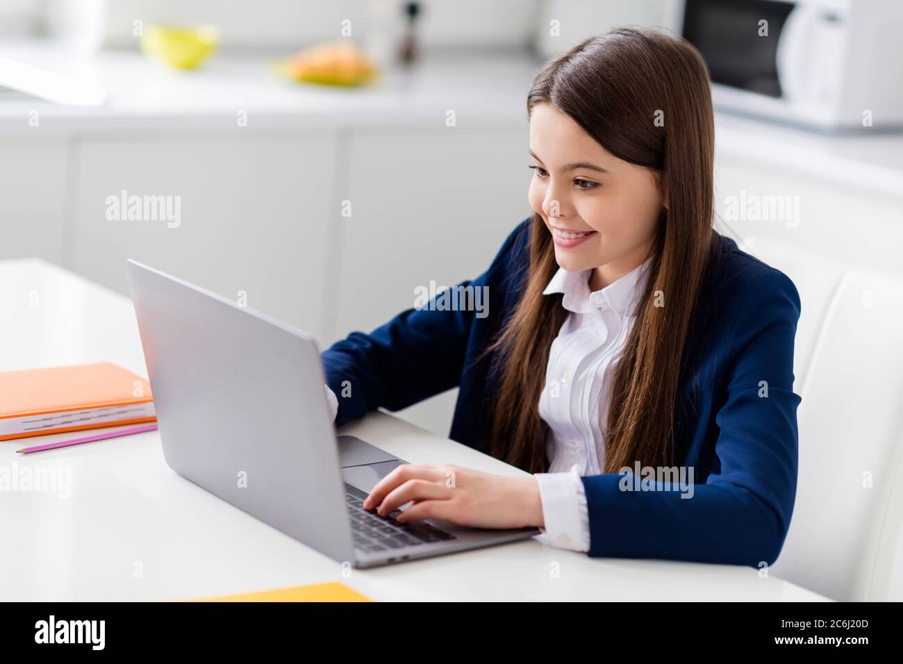 Photo of little pretty student school girl diligent student notebook ...