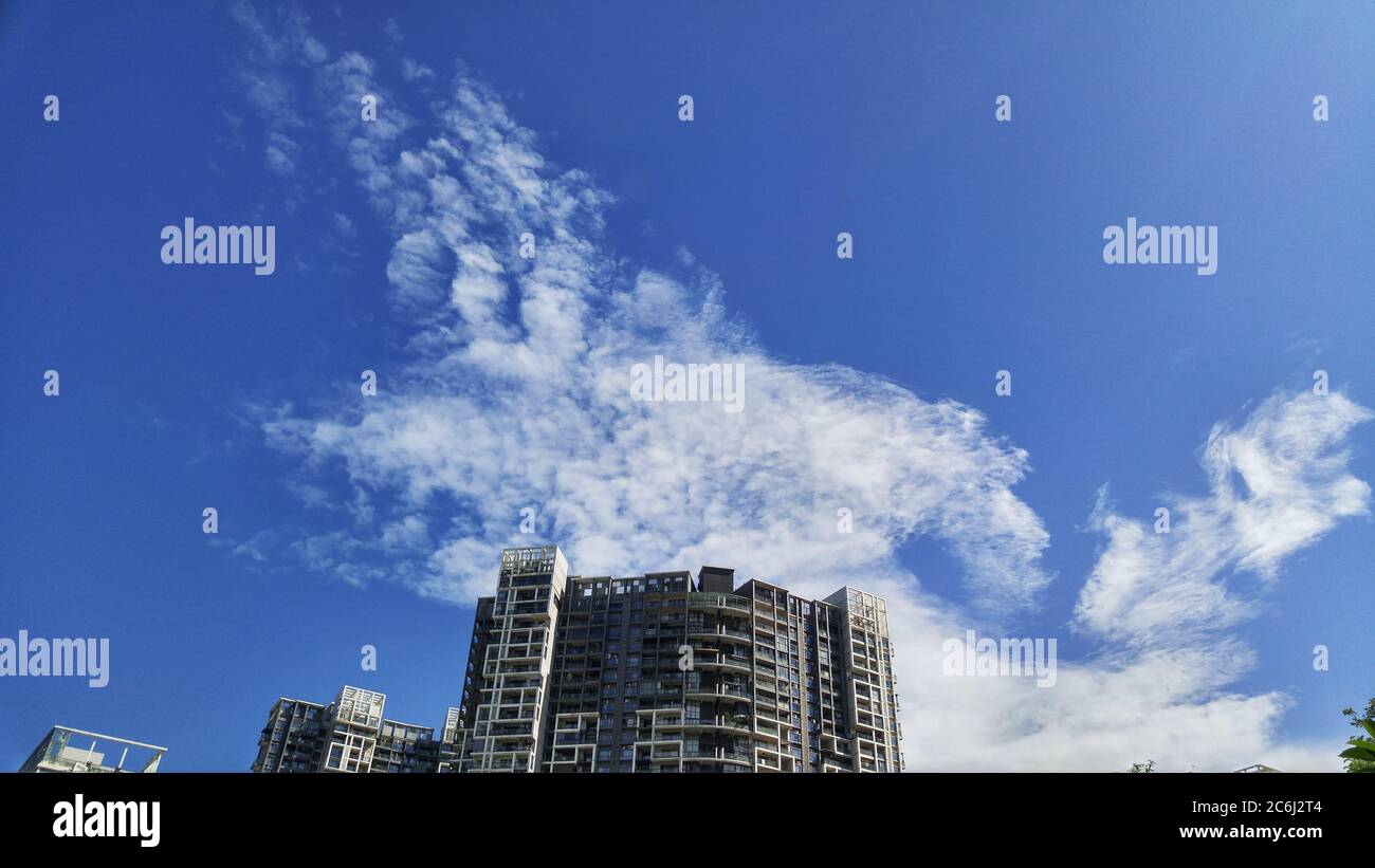 Shenzhen, China: residential buildings under blue sky and white clouds ...