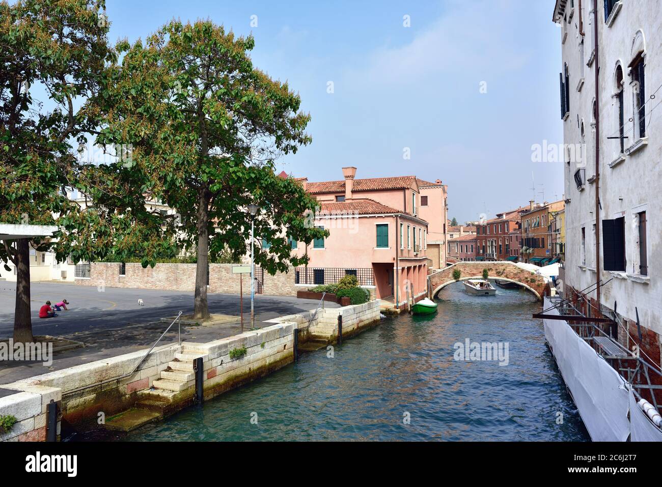 Venice canal and bridge at sunrise. Tourists from all the world enjoy ...
