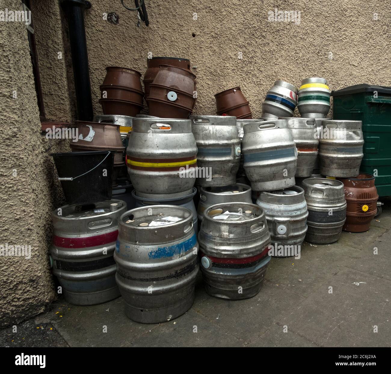 Various sized aluminum beer barrels stacked outside Stock Photo - Alamy