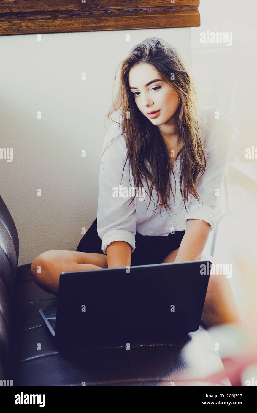 Photo of affable woman with long brown hair holding silver personal ...