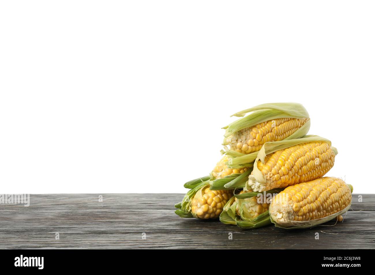 Corn on wooden table isolated on white background Stock Photo - Alamy