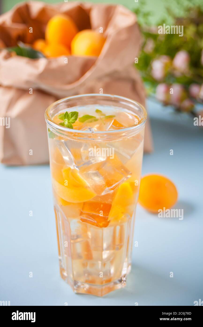 Summer cold drinks homemade apricot lemonade ice tea with ice cubes and ...