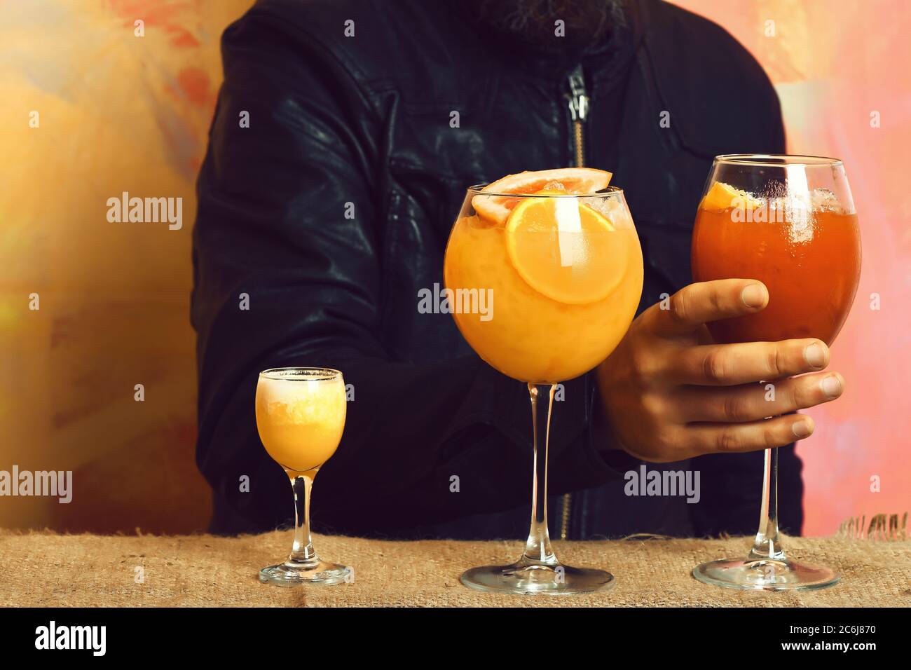 Male hand of caucasian man holding glass of alcoholic beverage or fresh ...