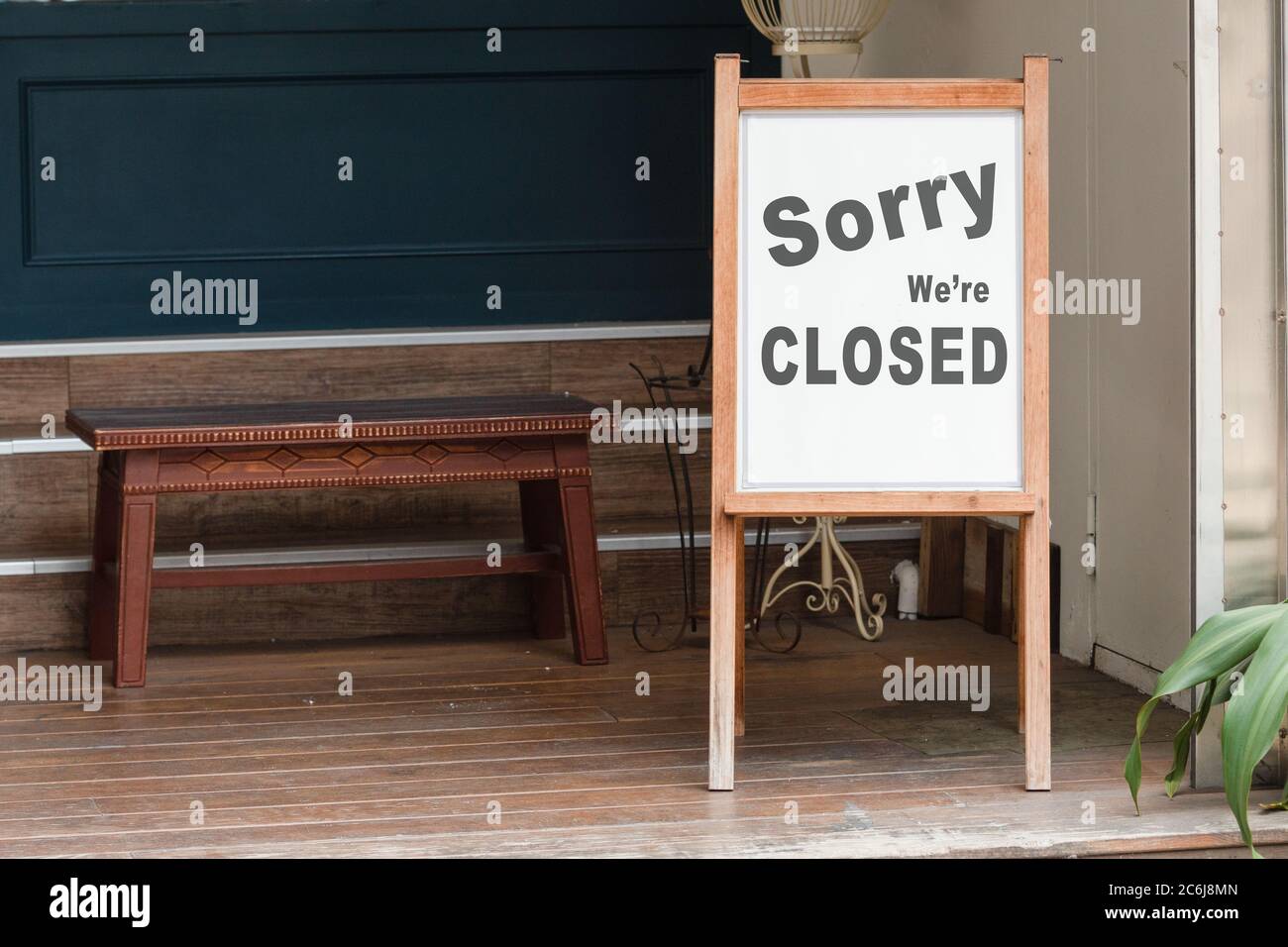 sorry we are closed sign hanging outside a restaurant, store, office or ...