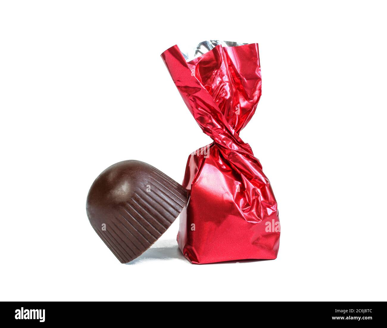 Milk chocolate candy in red glossy wrapping isolated on white ...