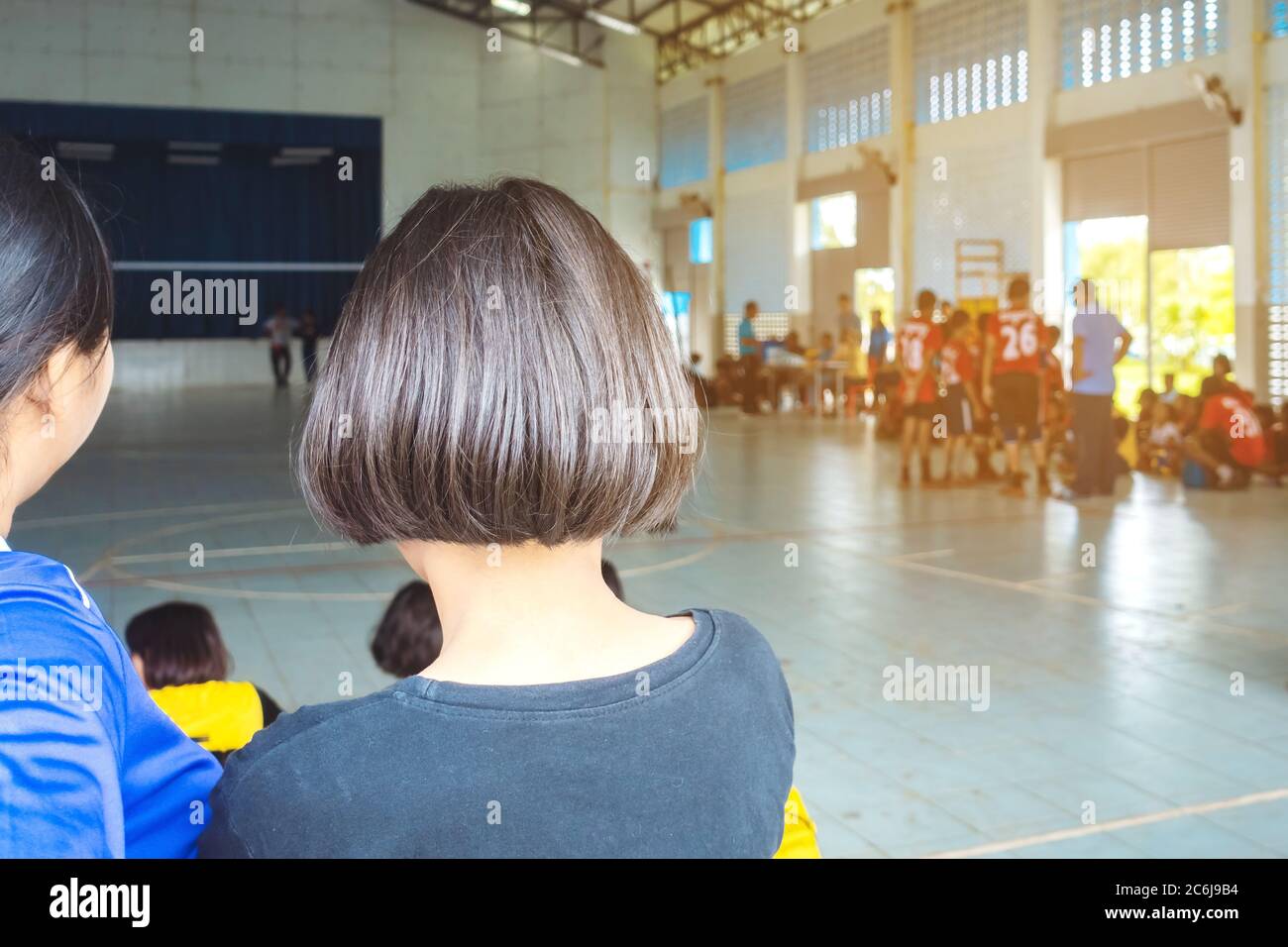 Back view of asian parents cheering childrens learn to playing ...