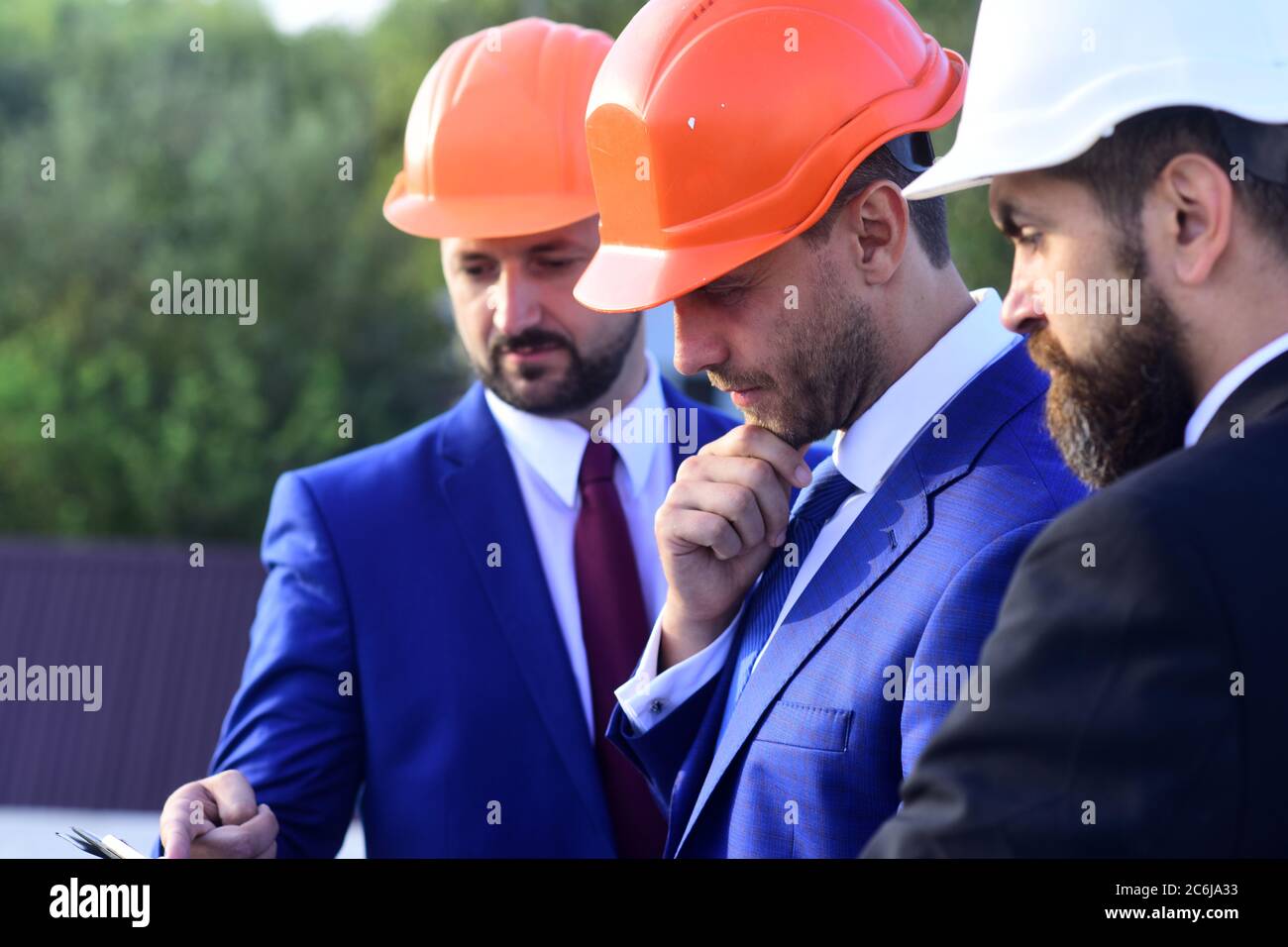 Leaders with beard and thoughtful faces discuss plan. Board of ...