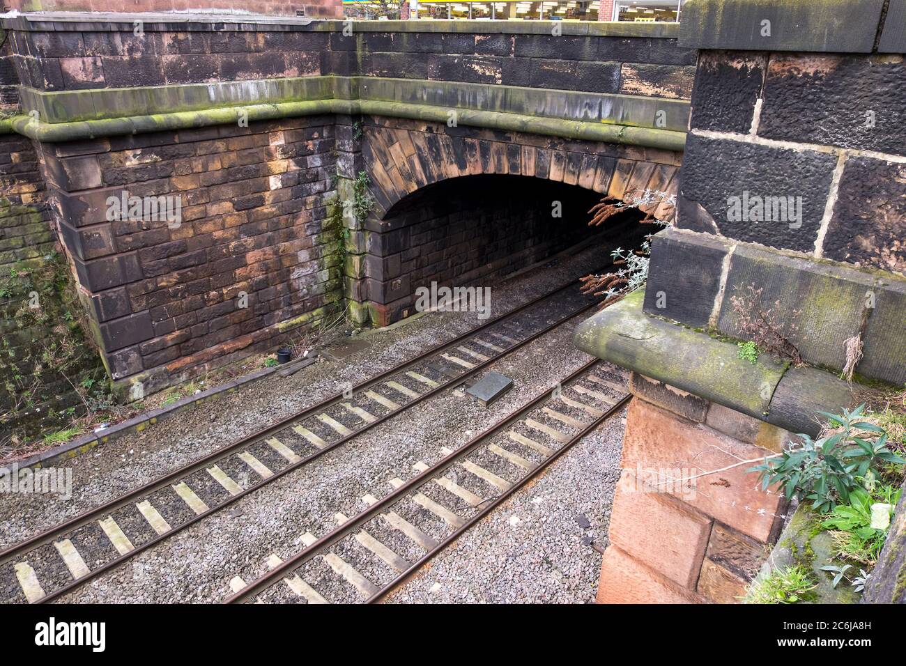 Two railway lines going into a tunnel Stock Photo - Alamy