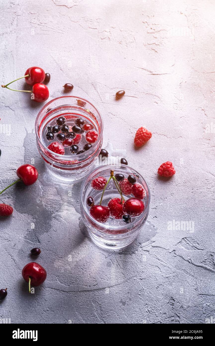 Fresh cold sparkling water drink with cherry, raspberry and currant ...