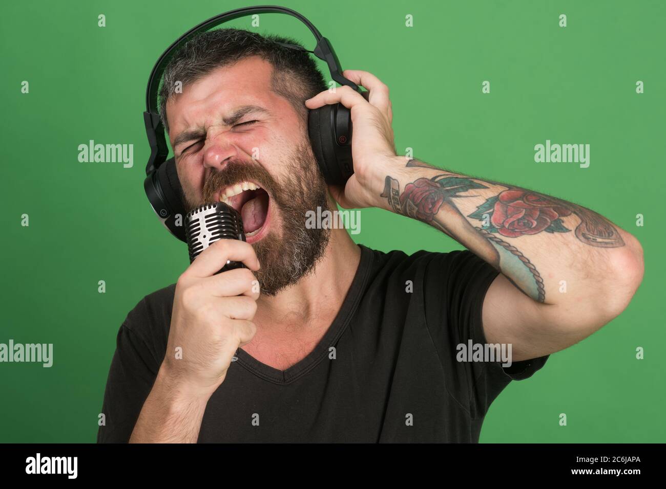 Singer with beard and excited face listens to music. Relax and music ...
