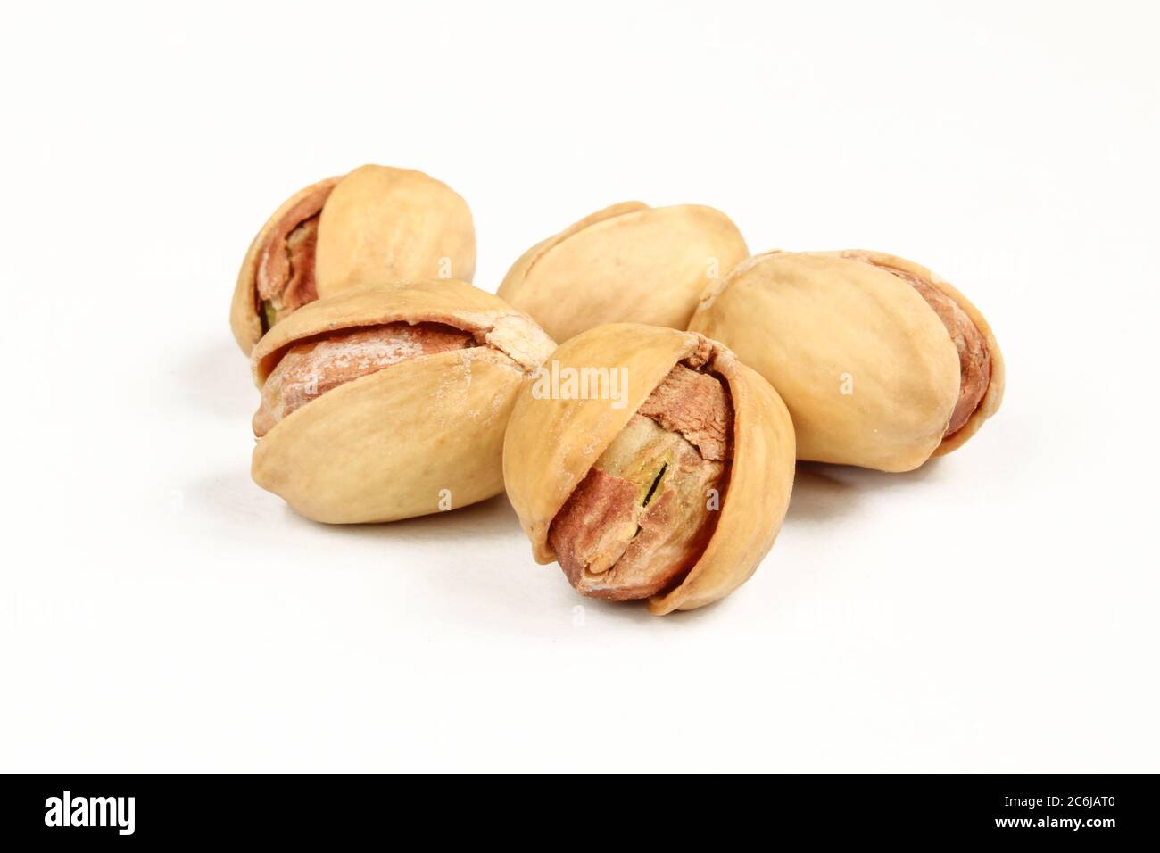 Group of raw and delicious pistachios in shell isolated on white ...