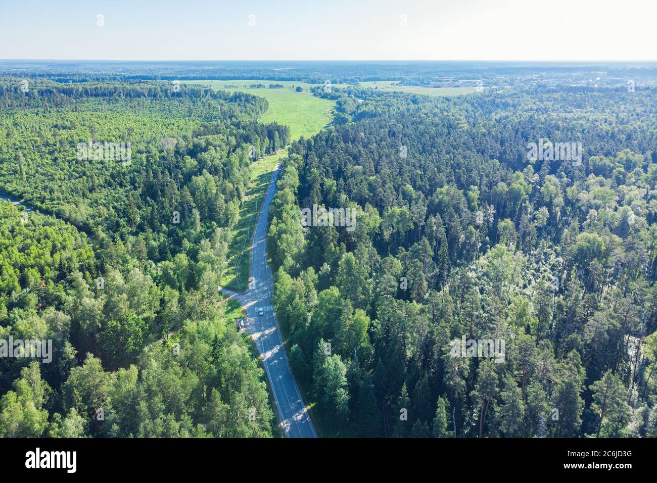 Green forest aerial drone view. Road in forest from above Stock Photo ...