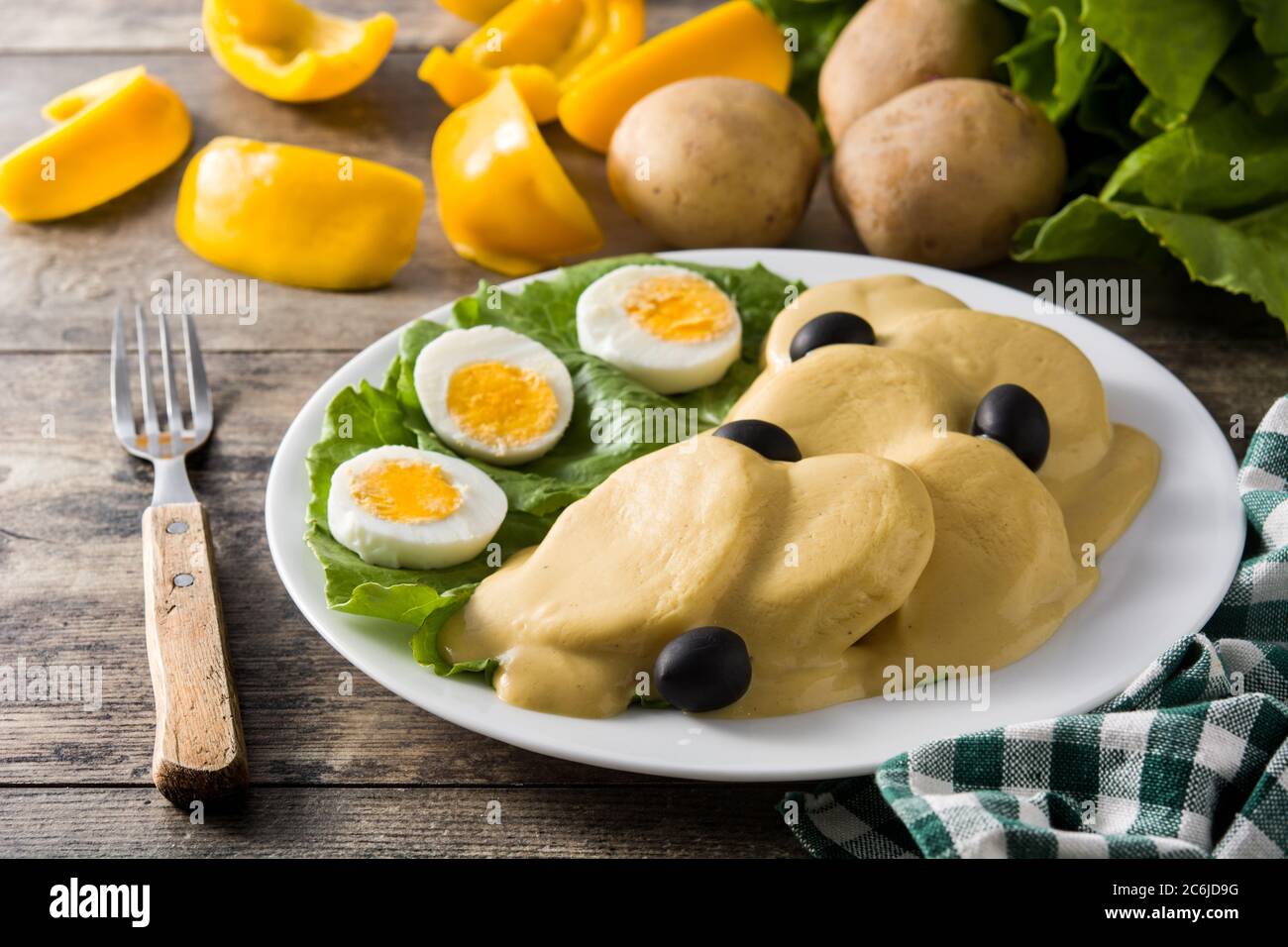 Traditional Peruvian papa a la huancaina on wooden table Stock Photo ...
