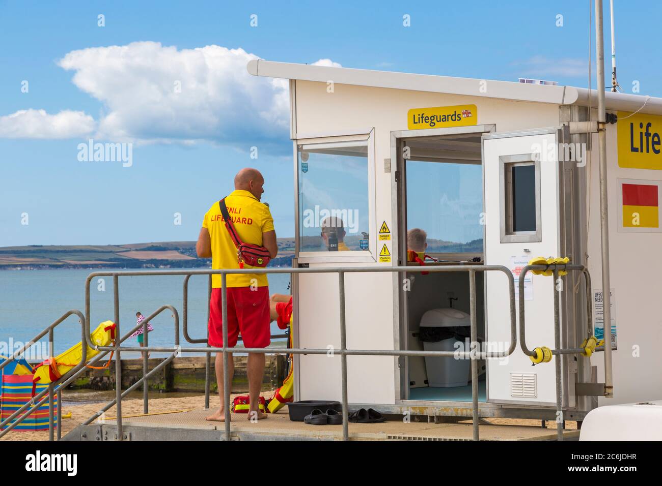 Lifeguard keeping a lookout lifeguard keeping a look out hi-res stock ...