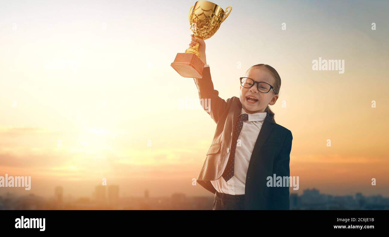 Little child is winner. Kid on sunset background. Smart power concept ...