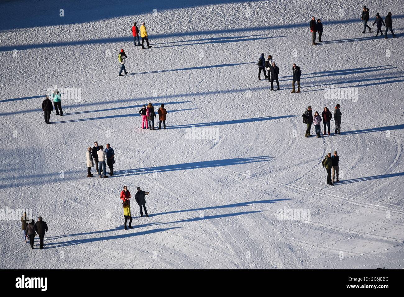 Spectators at the World Cup ski jump venue cast long shadows, Nordic ...