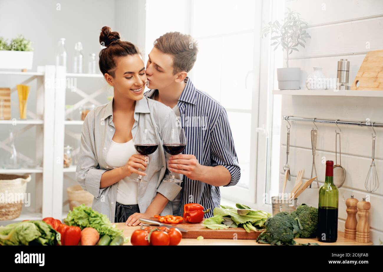 Healthy food at home. Happy loving couple is preparing the proper meal ...