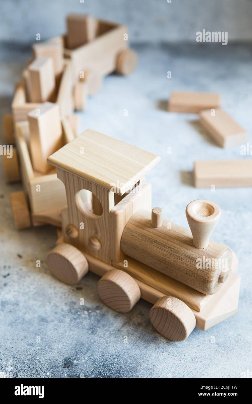 Children's wooden toys. Children wooden train with wagons. Natural wood ...
