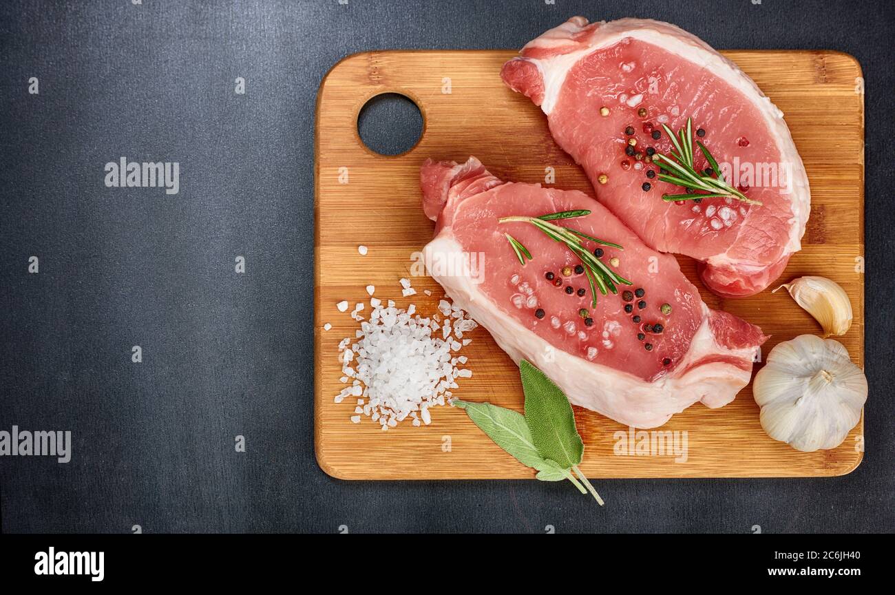 fresh meats on a black background Stock Photo - Alamy