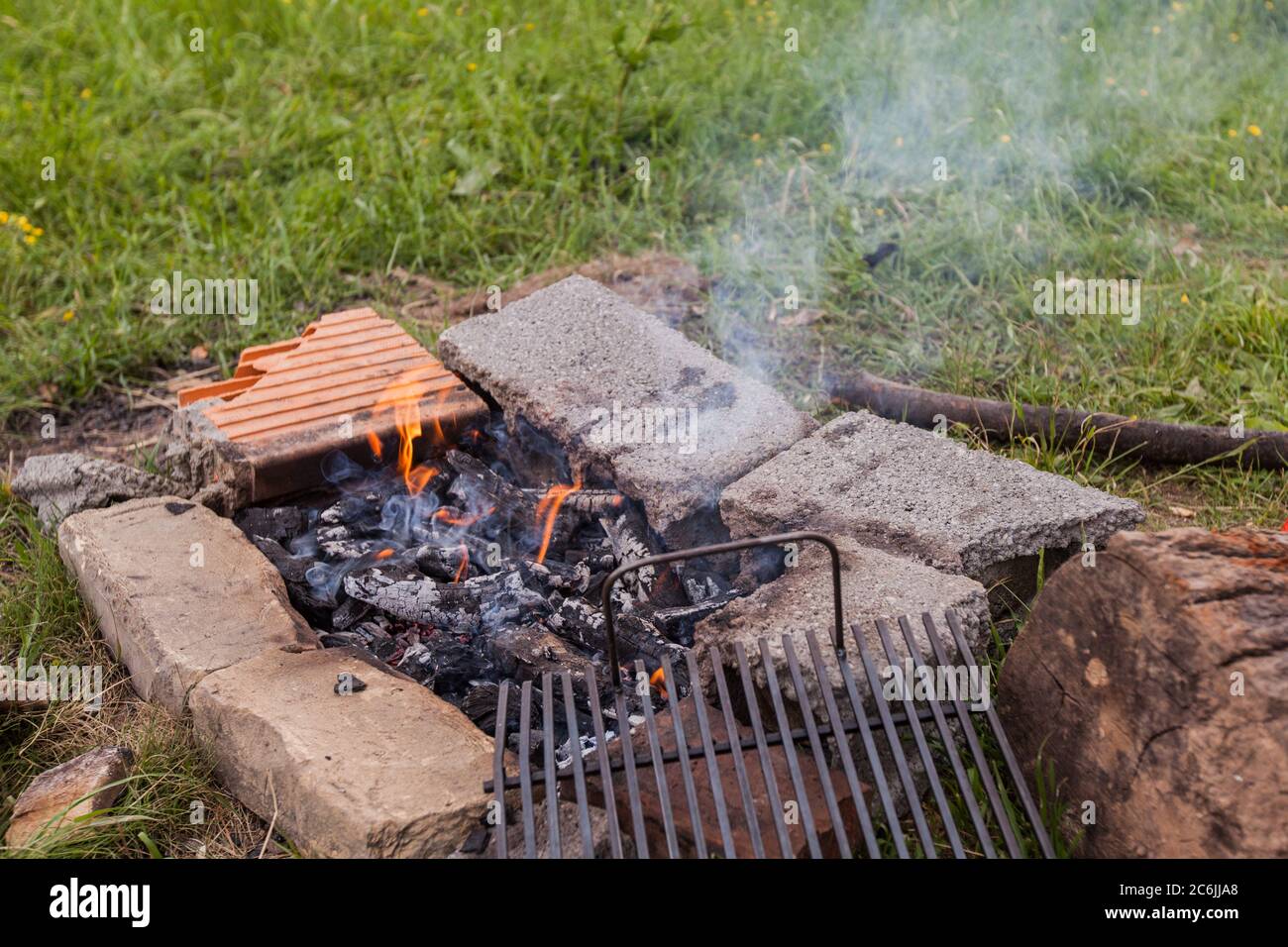 Fireplace for improvised barbecue at campsite in the nature Stock Photo ...