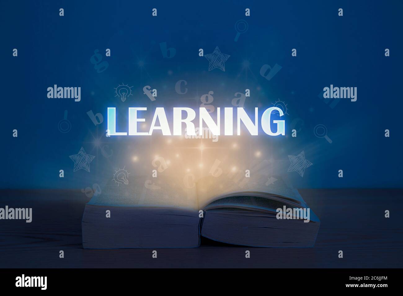 Learning concept. Light coming from open book. Open book with learning inscription Stock Photo ...