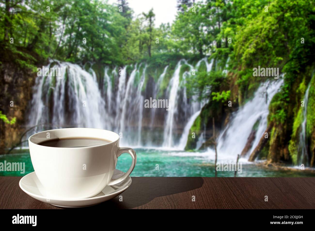 Cup of black coffee or tea with big waterfall background in Croatia ...
