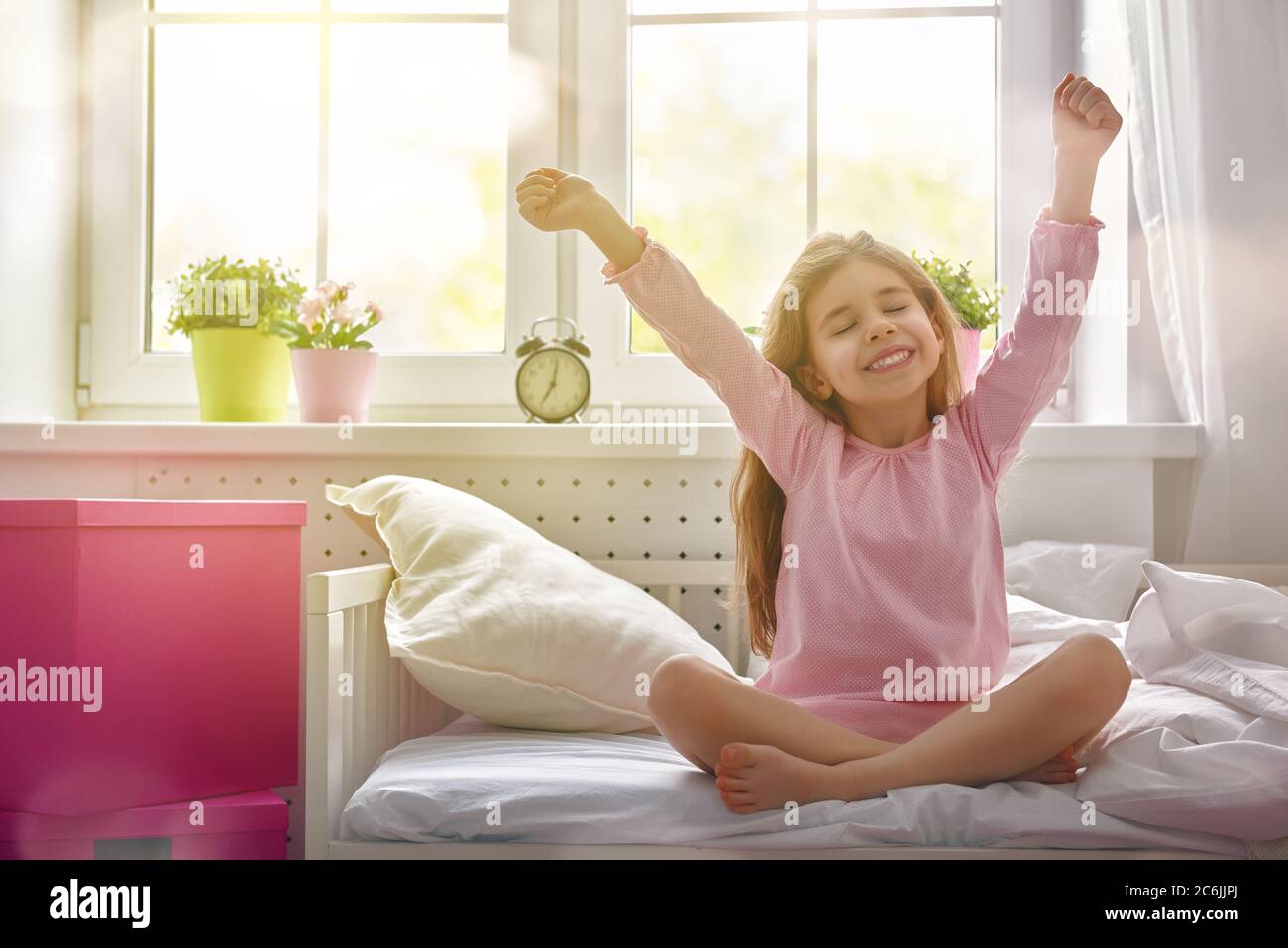 A nice child girl enjoys sunny morning. Good morning at home. Child ...