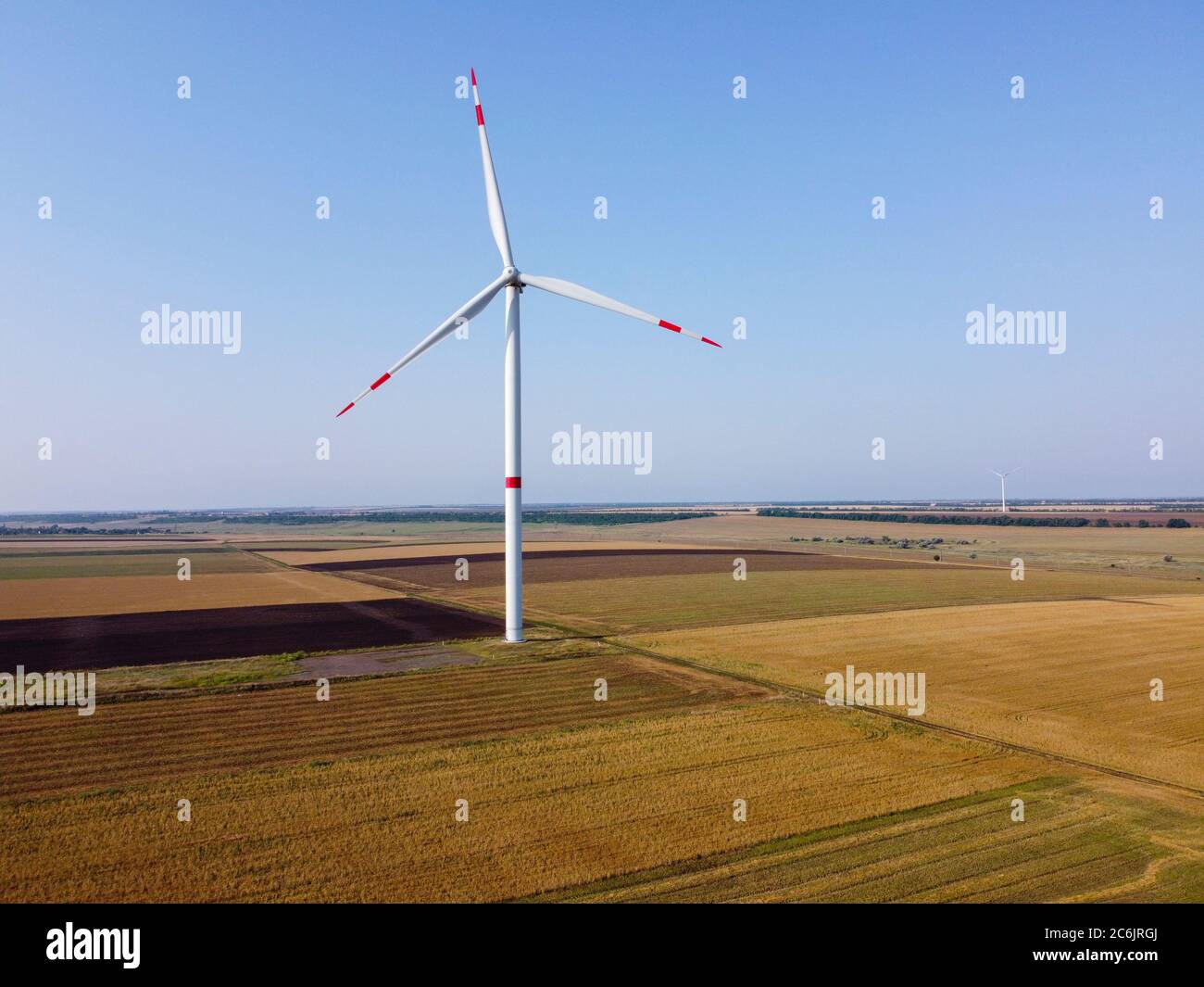 Wind power plant, a wind generator standing in a field where strong ...