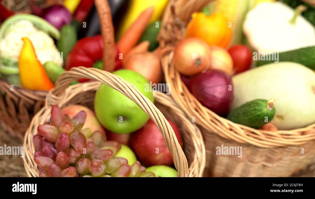 Summer fruits and vegetables in baskets. Abstract blurred image with ...