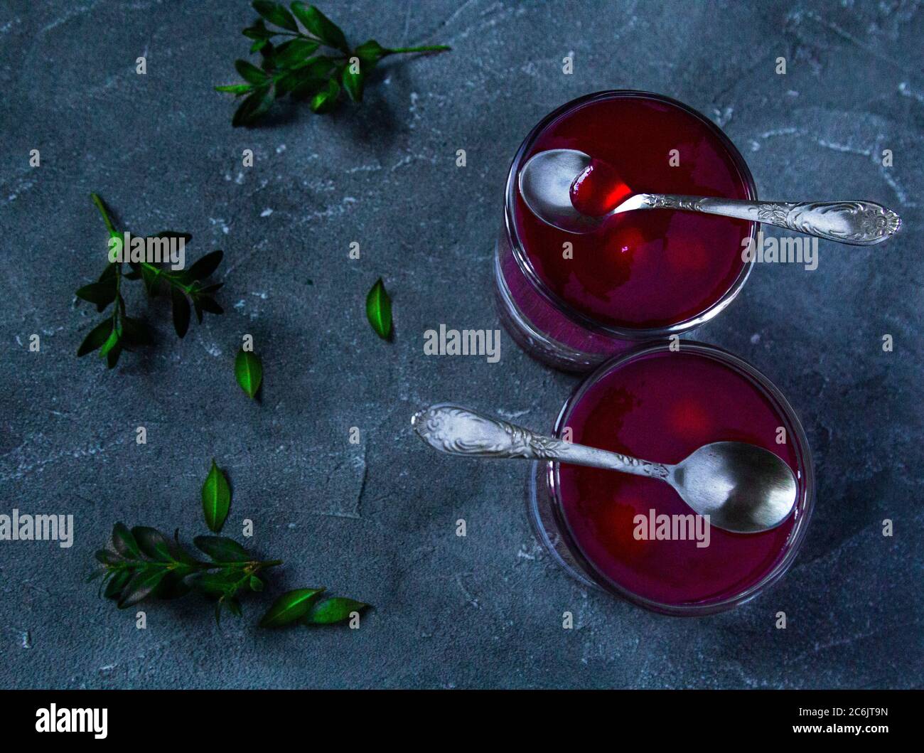 Russian traditional sweet drink kissel with cherries in two glasses on ...