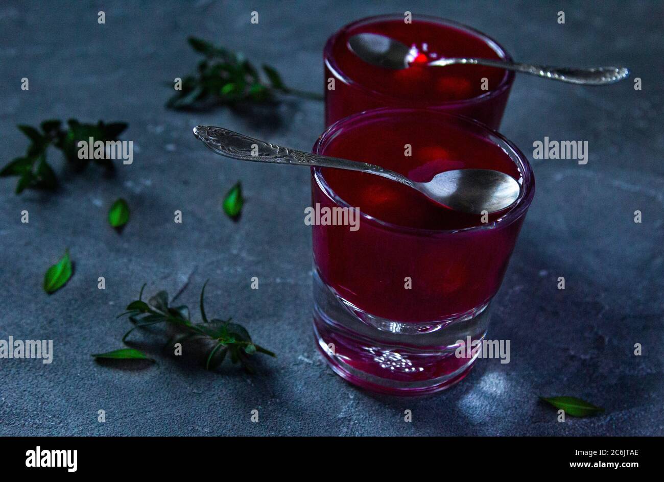Russian traditional sweet drink kissel with cherries in two glasses on ...