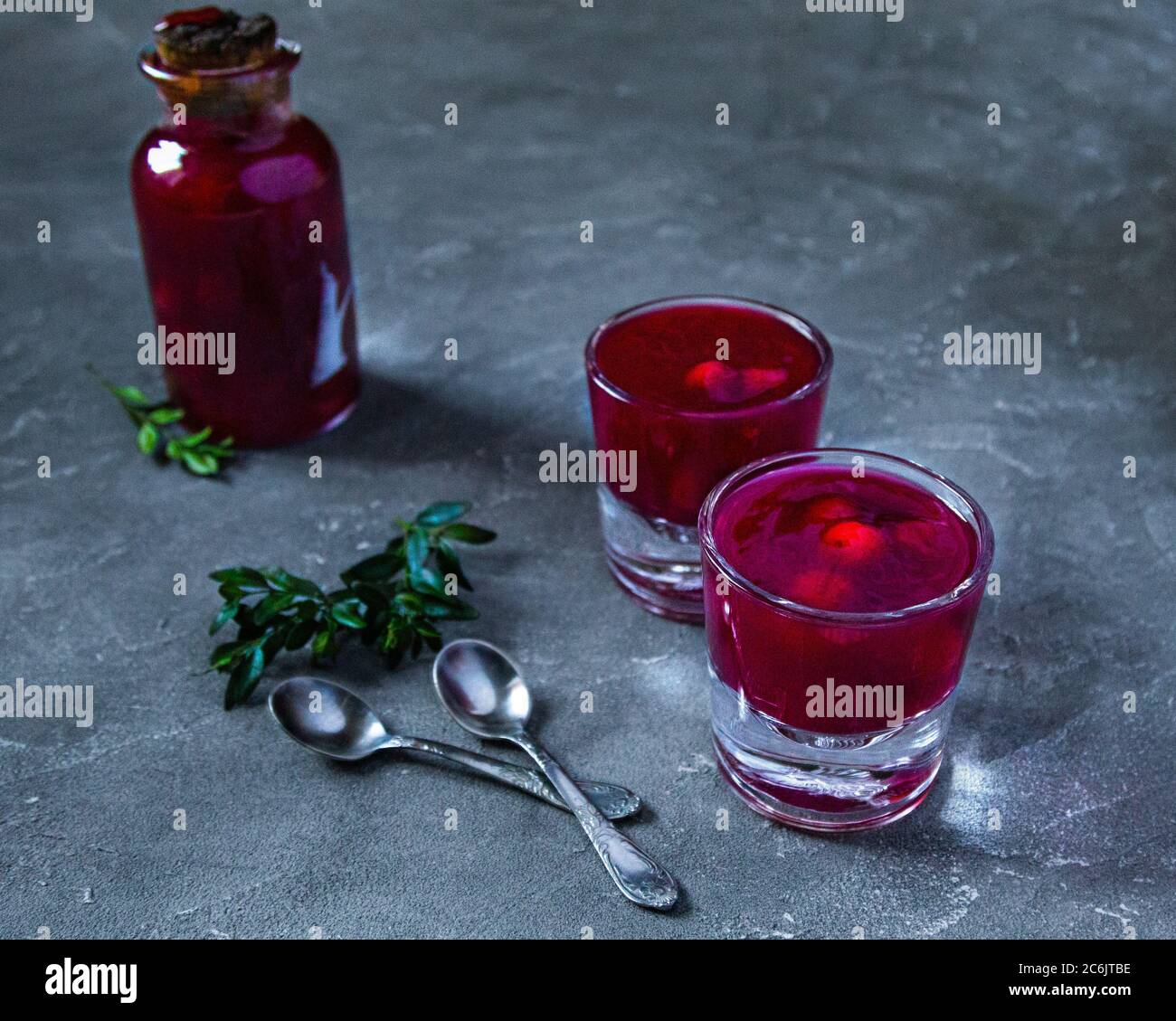 Russian traditional sweet drink kissel with cherries in two glasses and ...