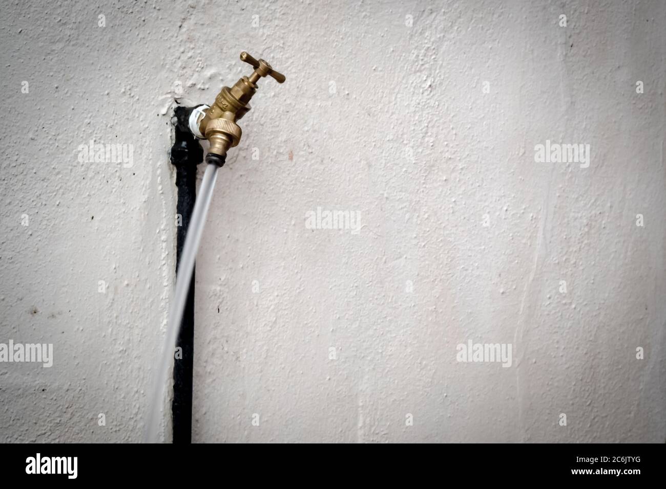 Isolated view of a running outside brass tap. Taken using a slow ...
