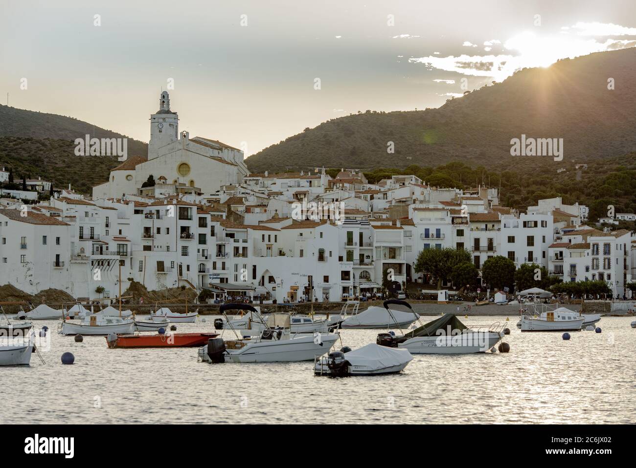 Boats in the beach and houses of the village of Cadaques, Spain Stock ...