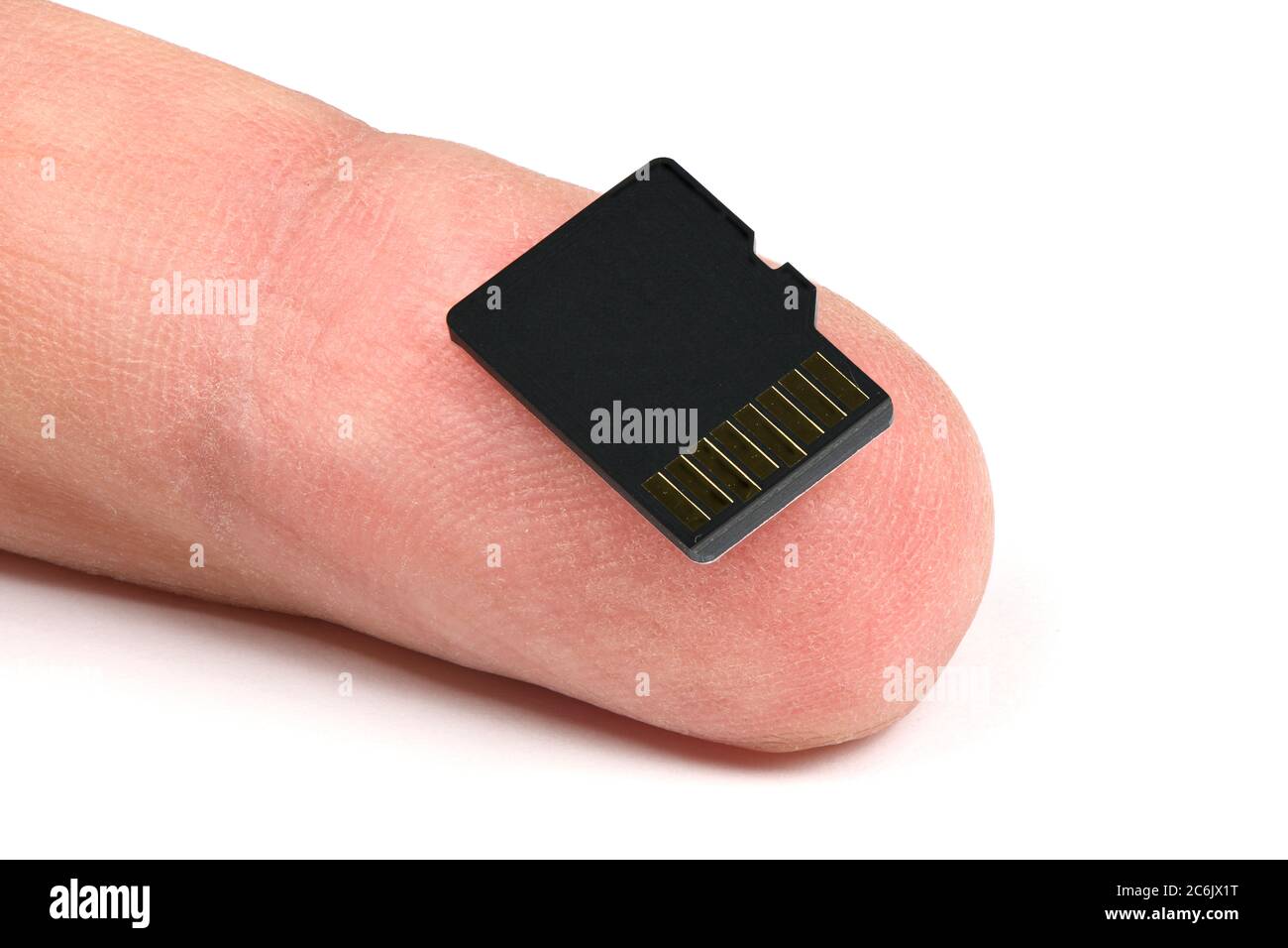 SD memory card on finger isolated on white background. High resolution ...