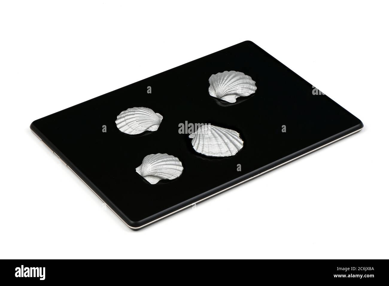 Silver seashell tablet pc isolated on wood background. High resolution ...