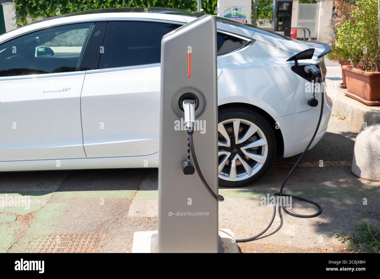 Puglia, Italy - Alberobello, a Tesla car is connected to an Enel ...