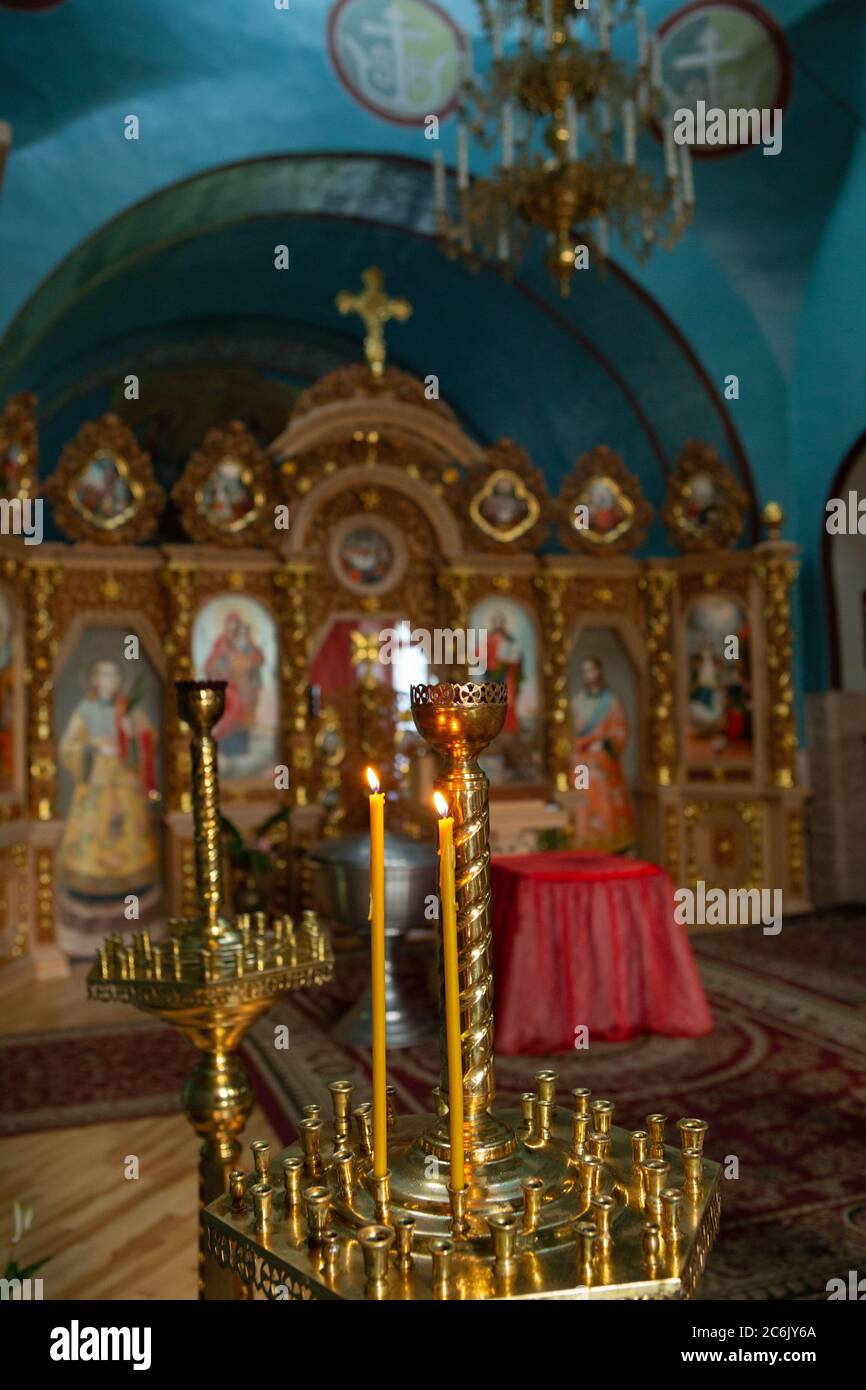 Burning candles before Iconostasis in church Interior. St. Peter's ...