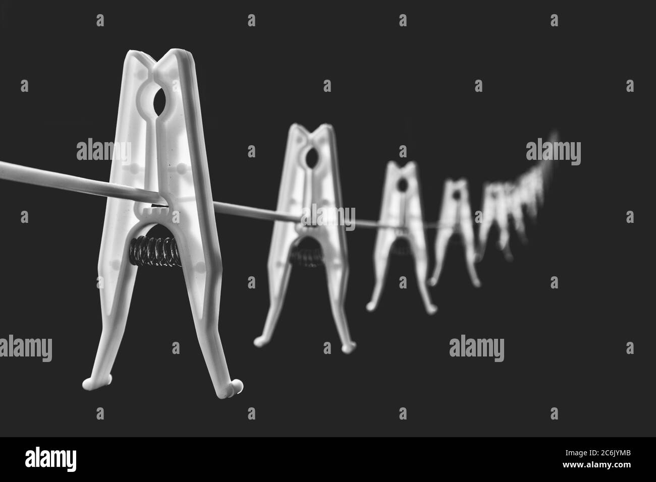 A line of washing pegs shot in high contrast Black & White Stock Photo ...