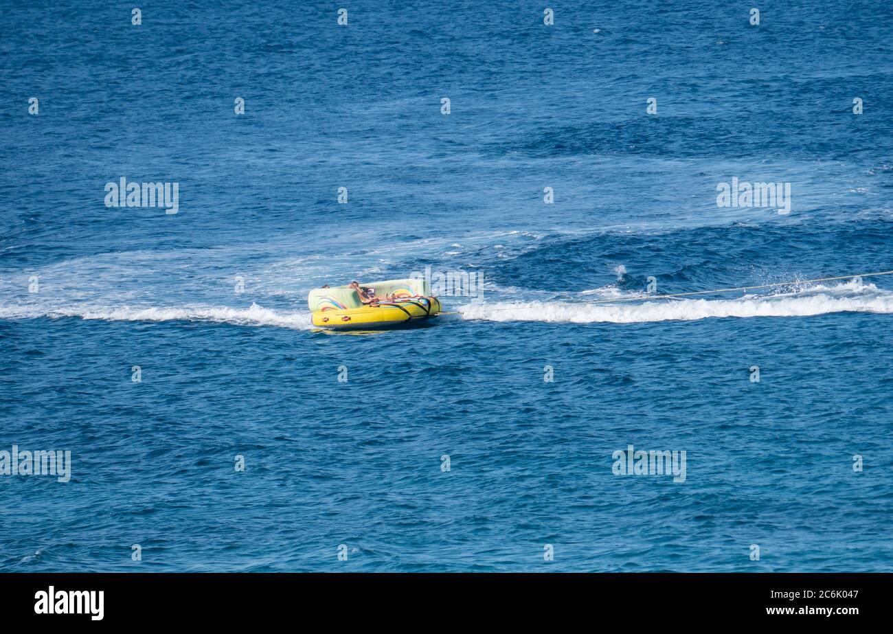 speedboat people tubing on the blue sea Stock Photo - Alamy