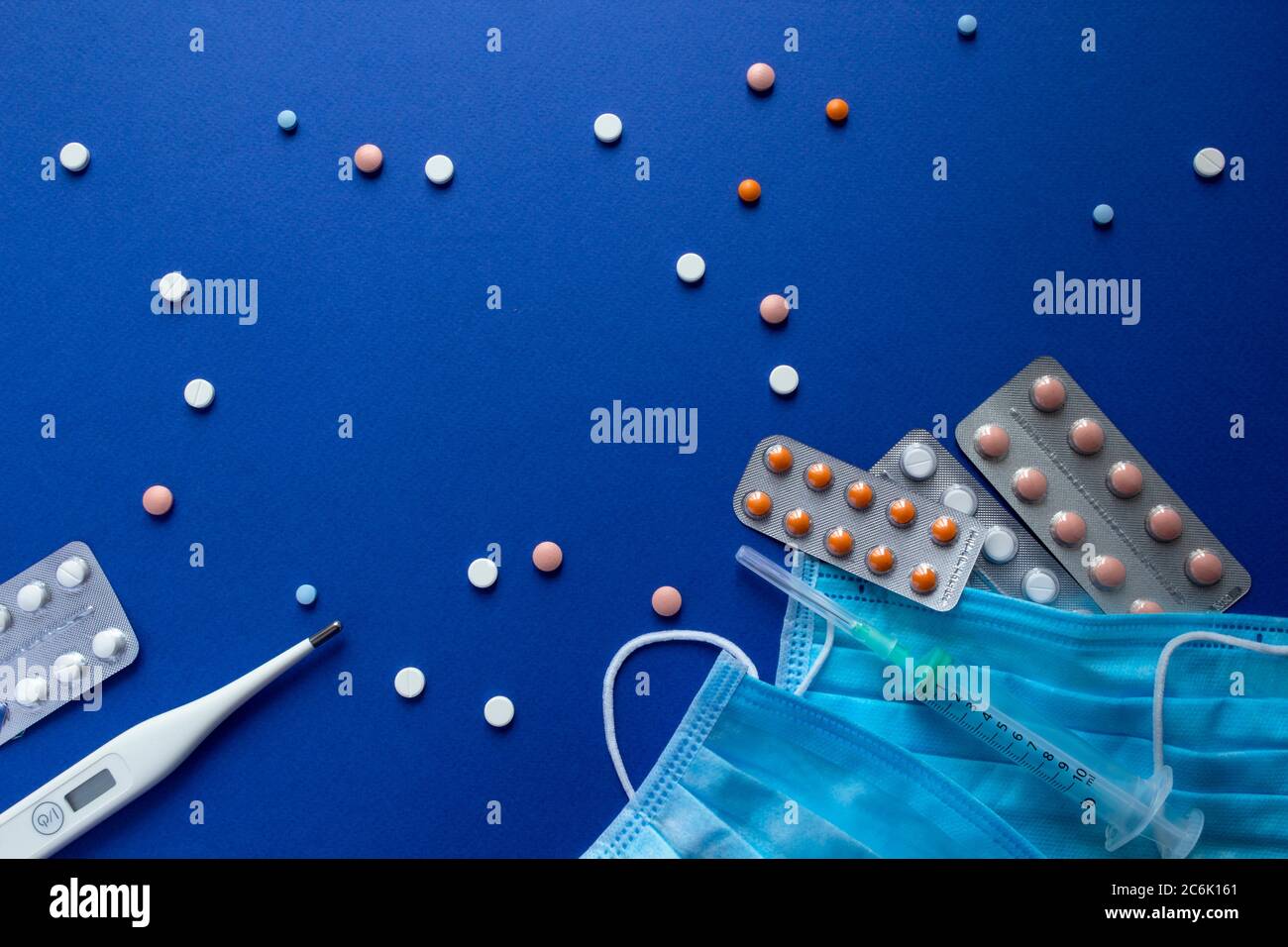 Pills, tablets in blister, Thermometer, syringe and protective masks ...